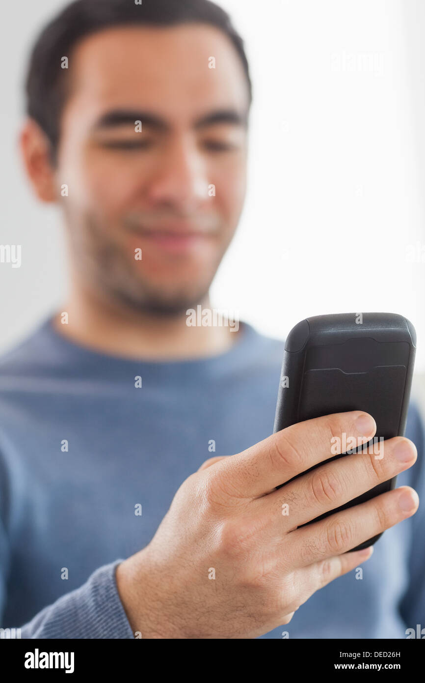 Happy casual man sending a text message Stock Photo - Alamy