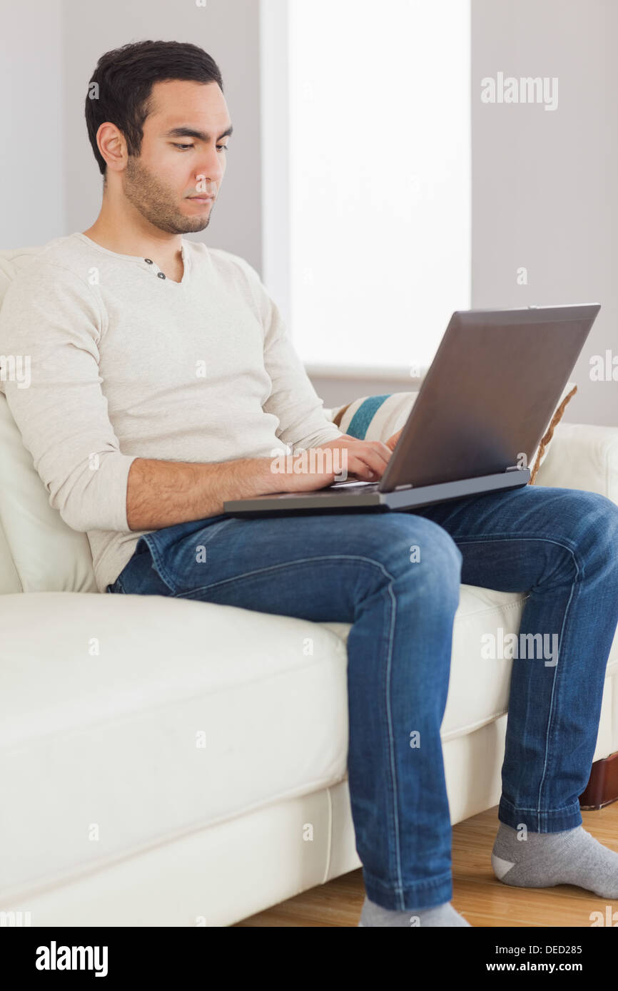 Focused handsome man using his tablet computer Stock Photo - Alamy