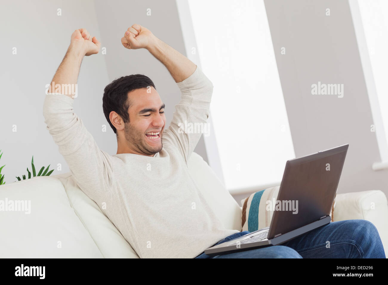 Excited man looking laptop hi-res stock photography and images - Alamy