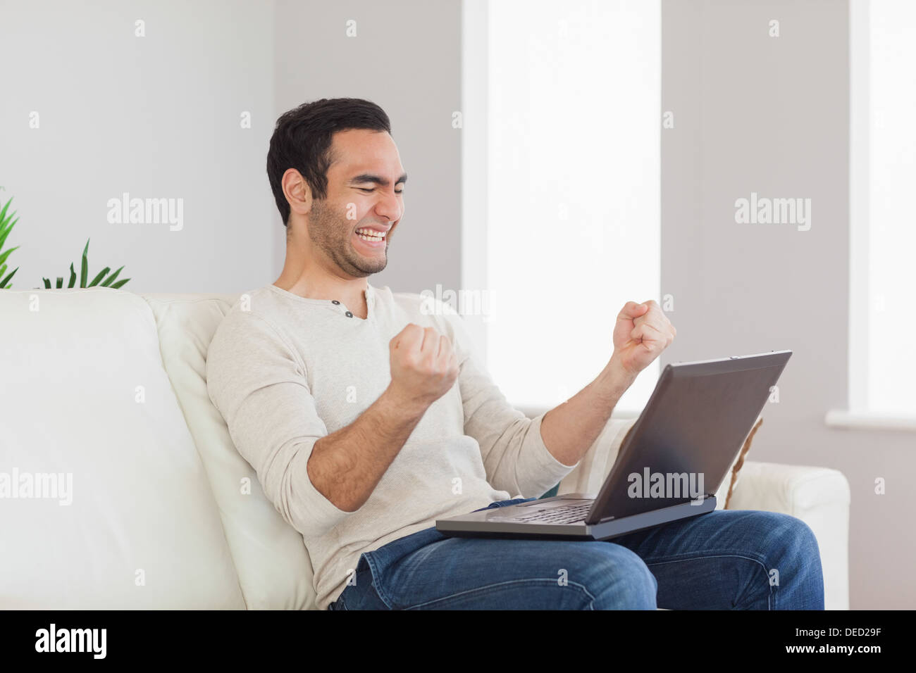 Successful handsome man looking at his laptop Stock Photo - Alamy