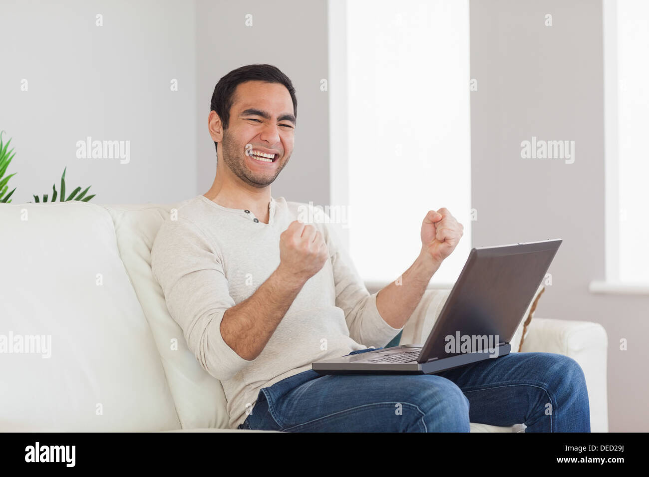 Successful casual man cheering Stock Photo - Alamy