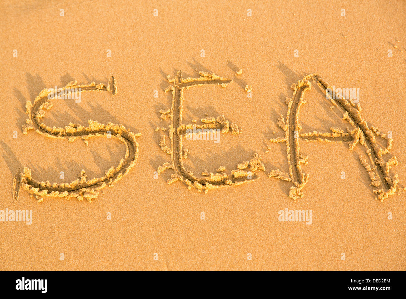 Word sea on the yellow sandy beach, text Stock Photo - Alamy