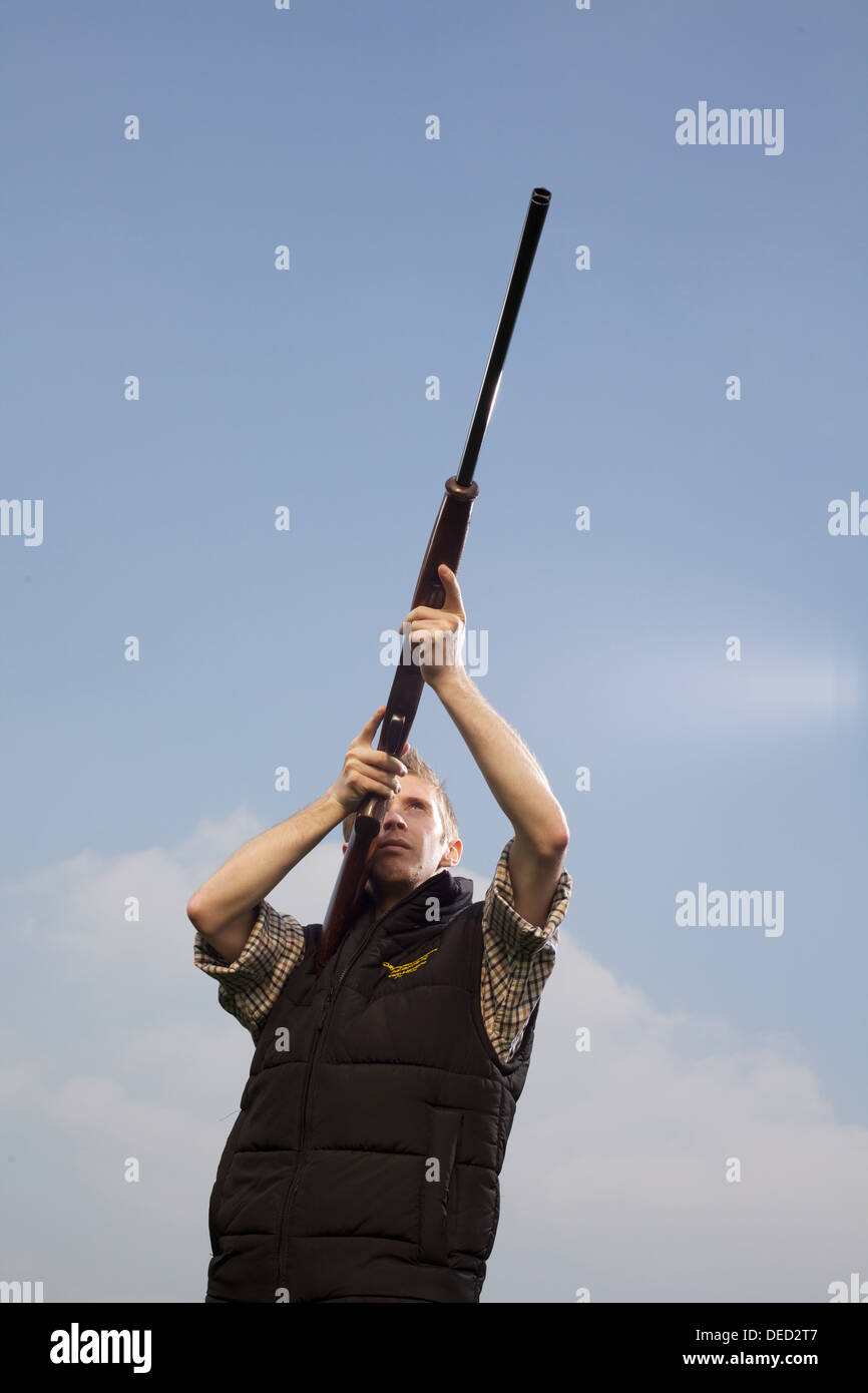 man holding shotgun in firing position Stock Photo - Alamy