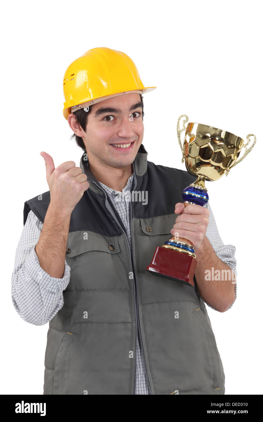 Construction worker with trophy Stock Photo - Alamy