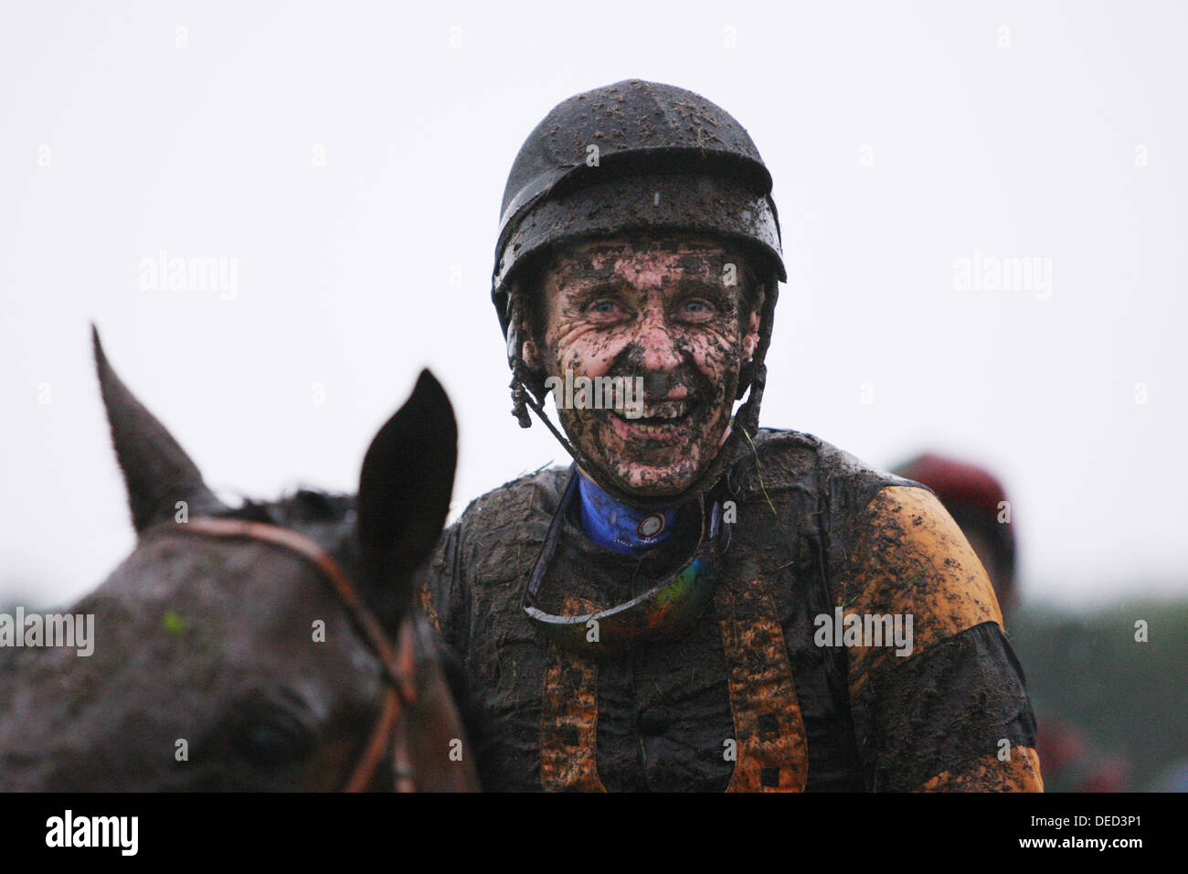 Hannover, Germany, Jockey laughs with dirt smeared face at the races ...