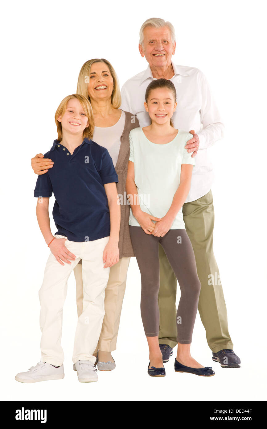 young grandmother and grandfather with nephew and niece standing on ...