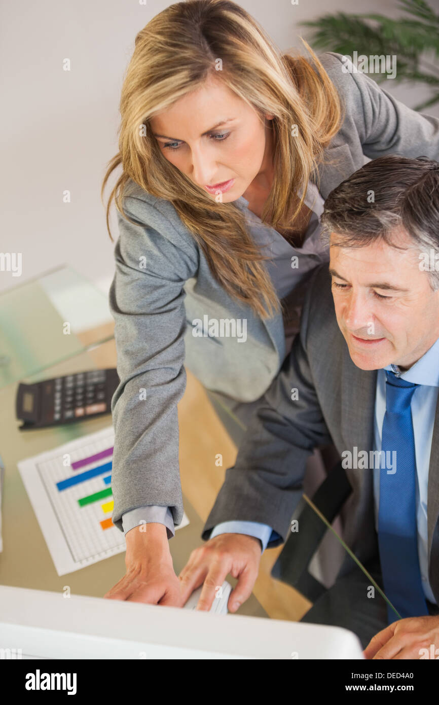 Colleagues looking computer screen in hi-res stock photography and ...
