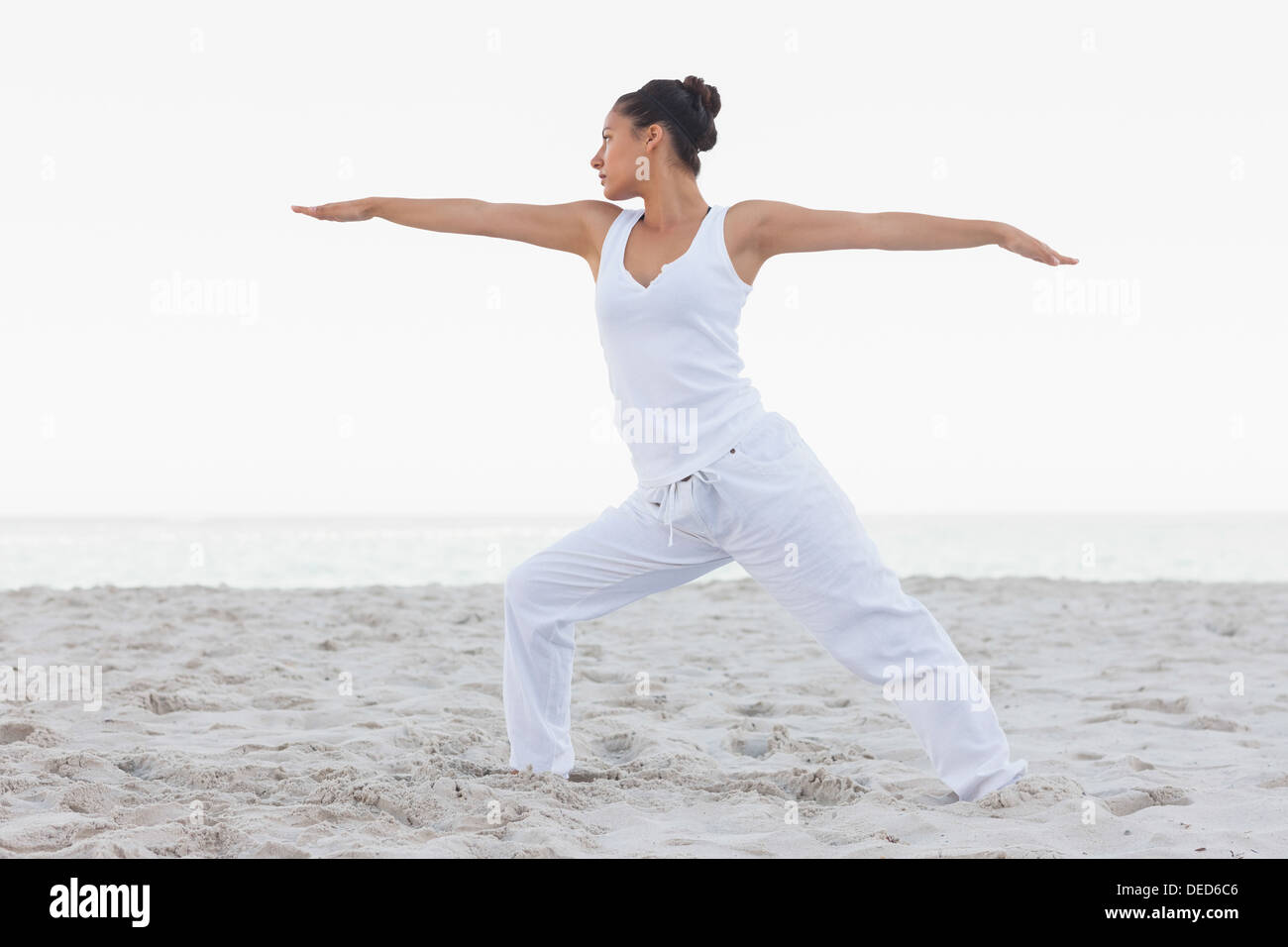 Brunette woman stretching in yoga pose Stock Photo - Alamy