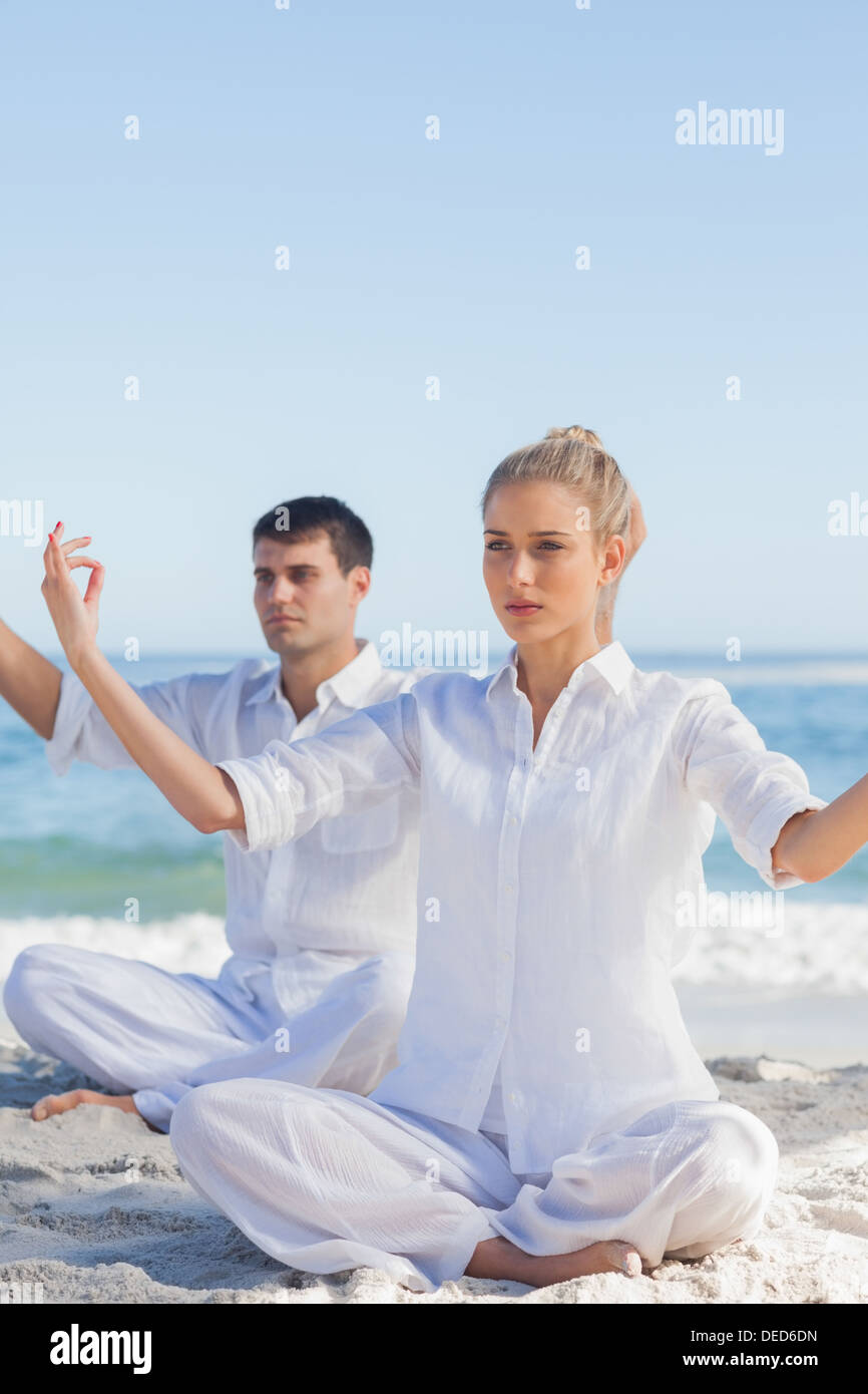 Attractive people doing yoga exercises Stock Photo - Alamy