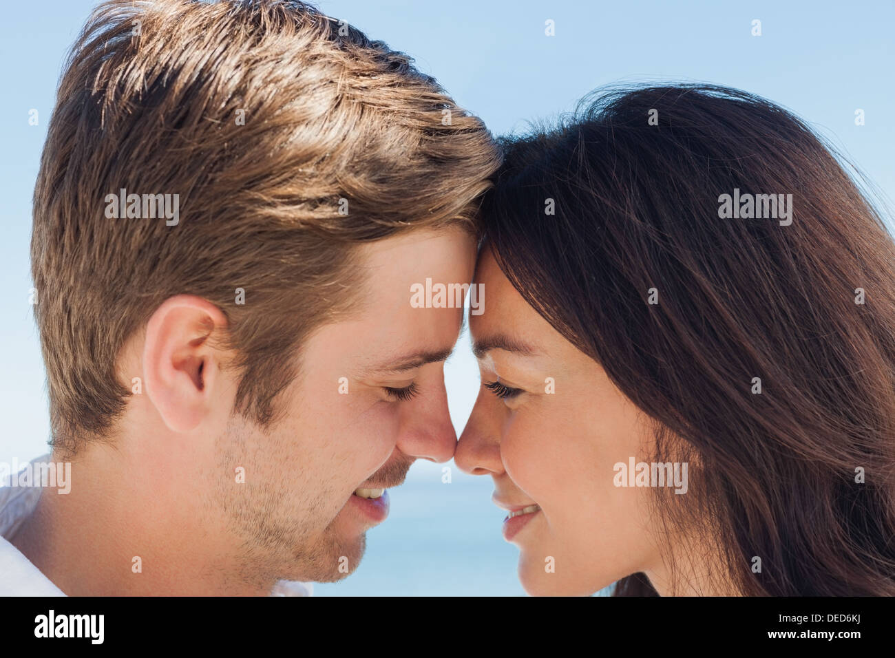 Happy romantic couple standing close hi-res stock photography and images - Alamy