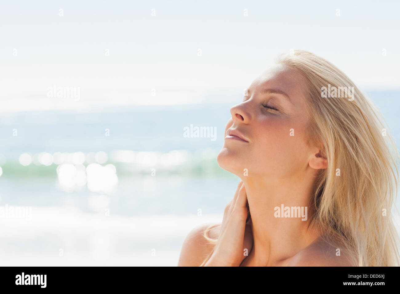 Beautiful woman enjoying the sun Stock Photo - Alamy