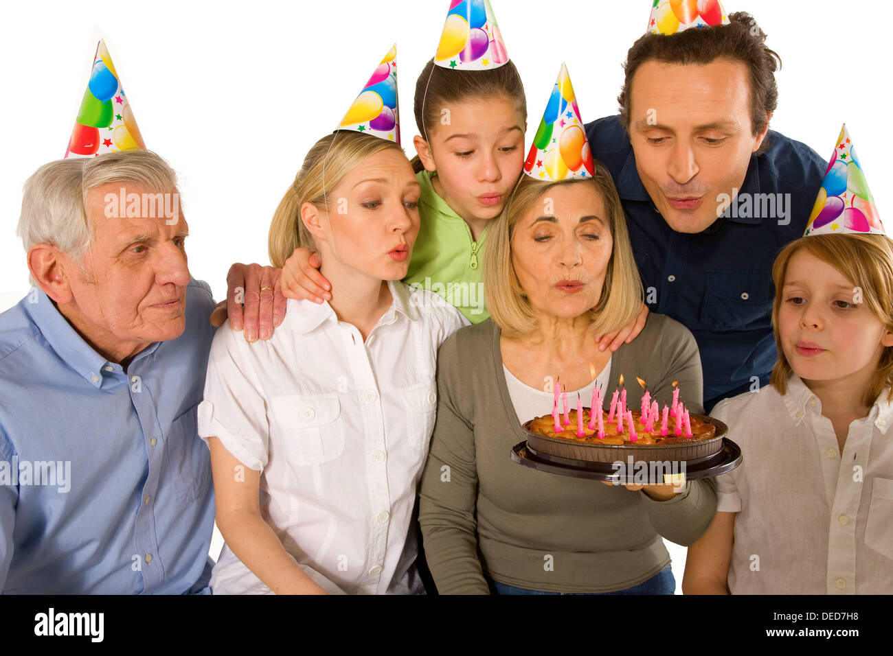 family celebrating birthday party with cake Stock Photo - Alamy