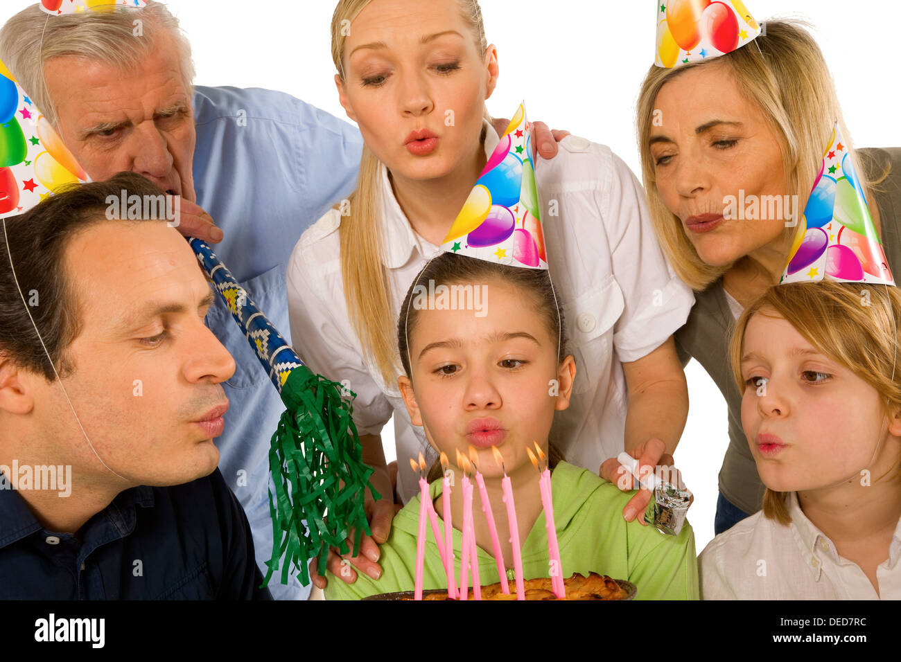 family celebrating birthday party with cake blowing candels Stock Photo ...