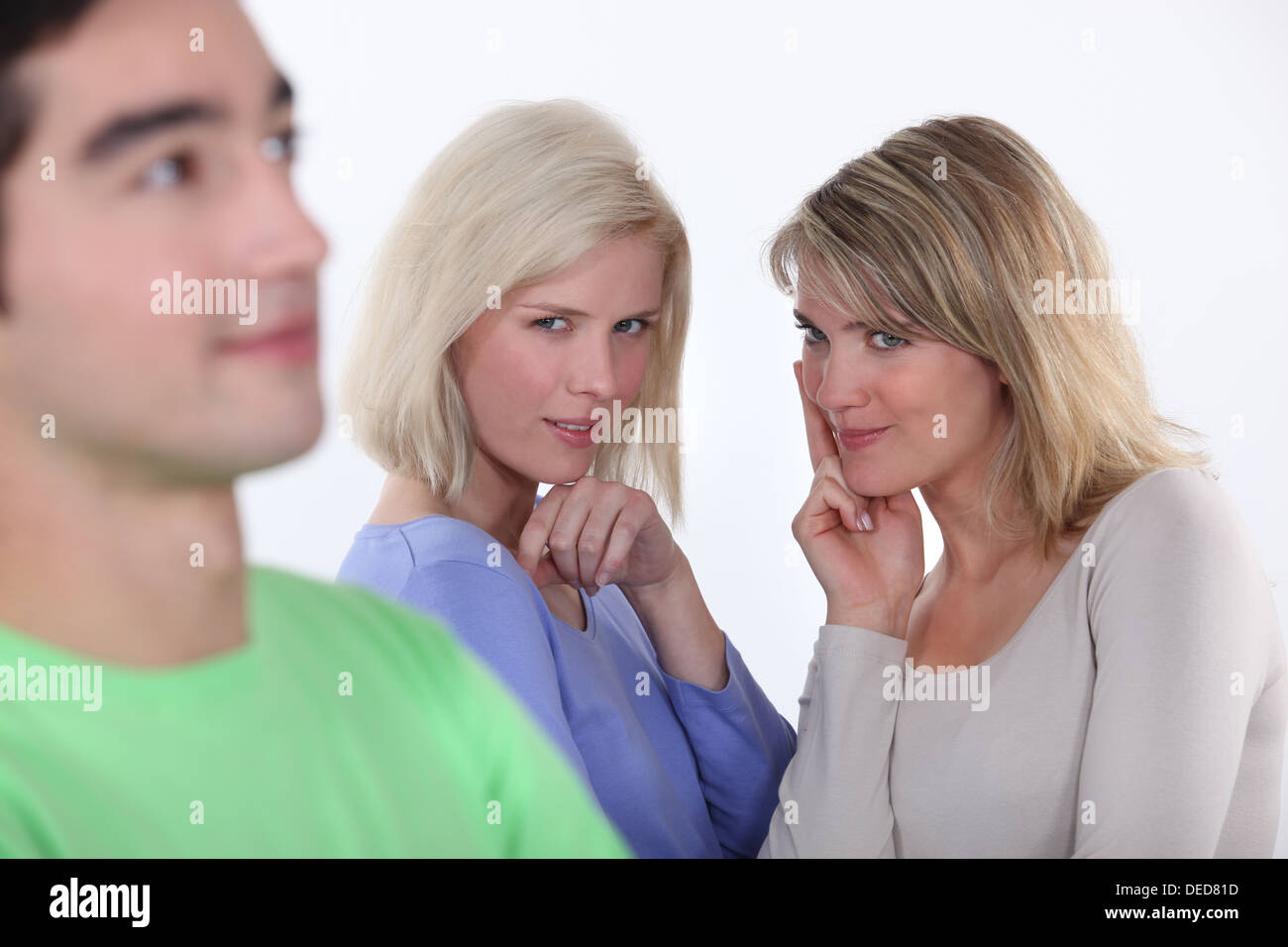 Women observing a man Stock Photo - Alamy