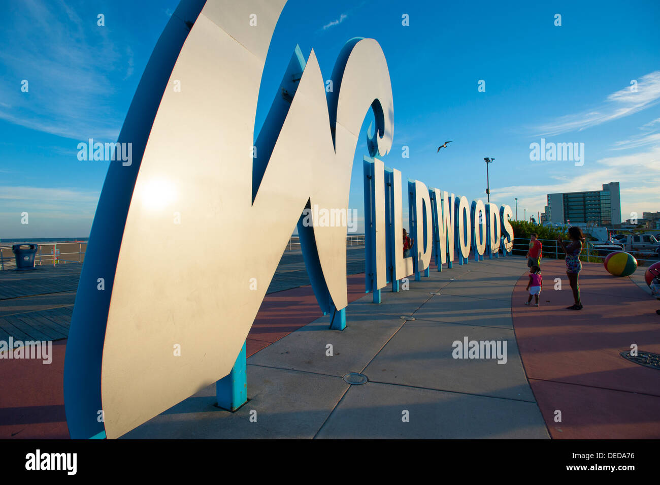 USA New Jersey NJ Wildwoods boardwalk and sign people gather and play ...