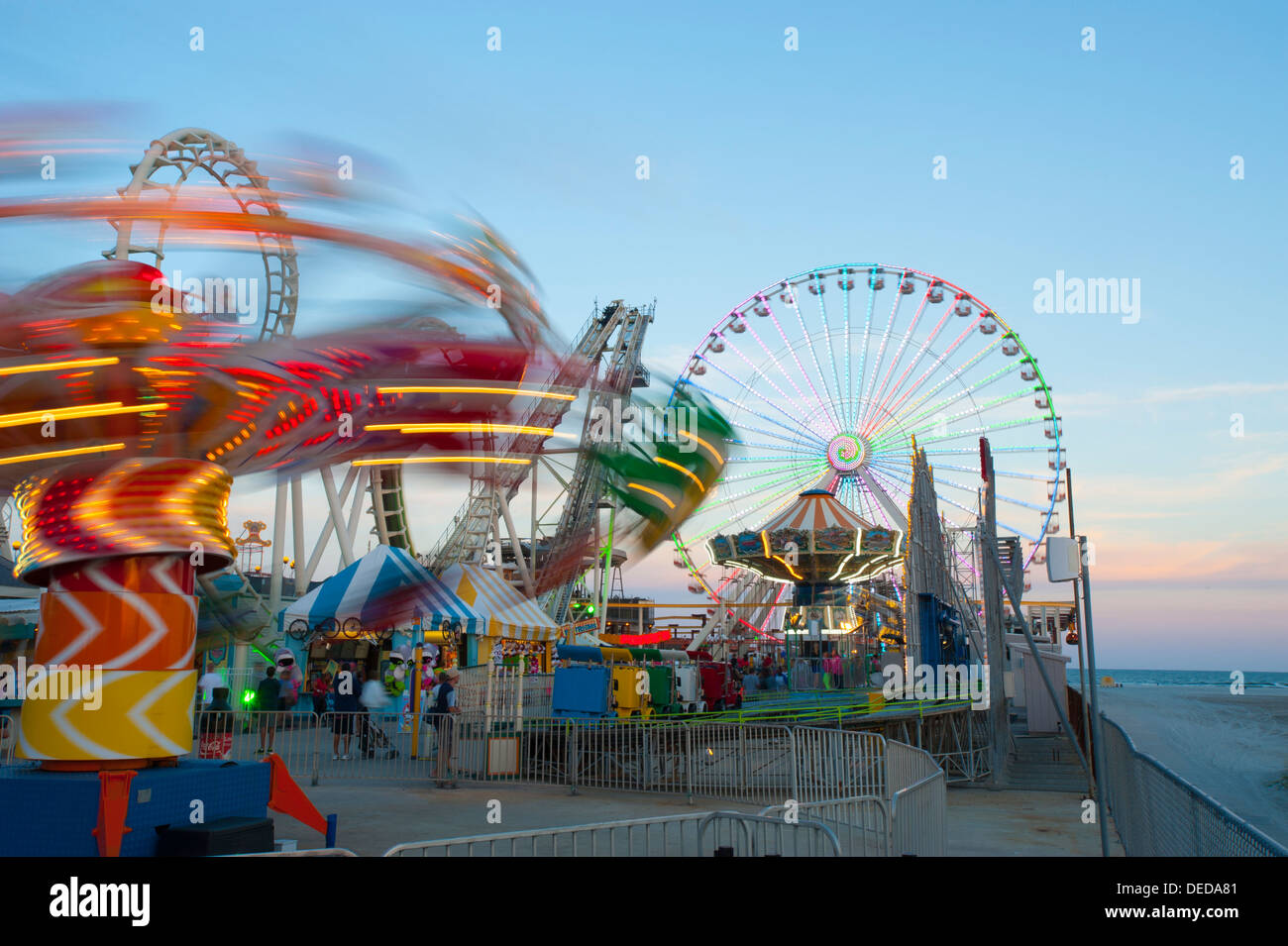 USA New Jersey NJ Shore Wildwood boardwalk at night food games rides nightlife fun twilight dusk ...