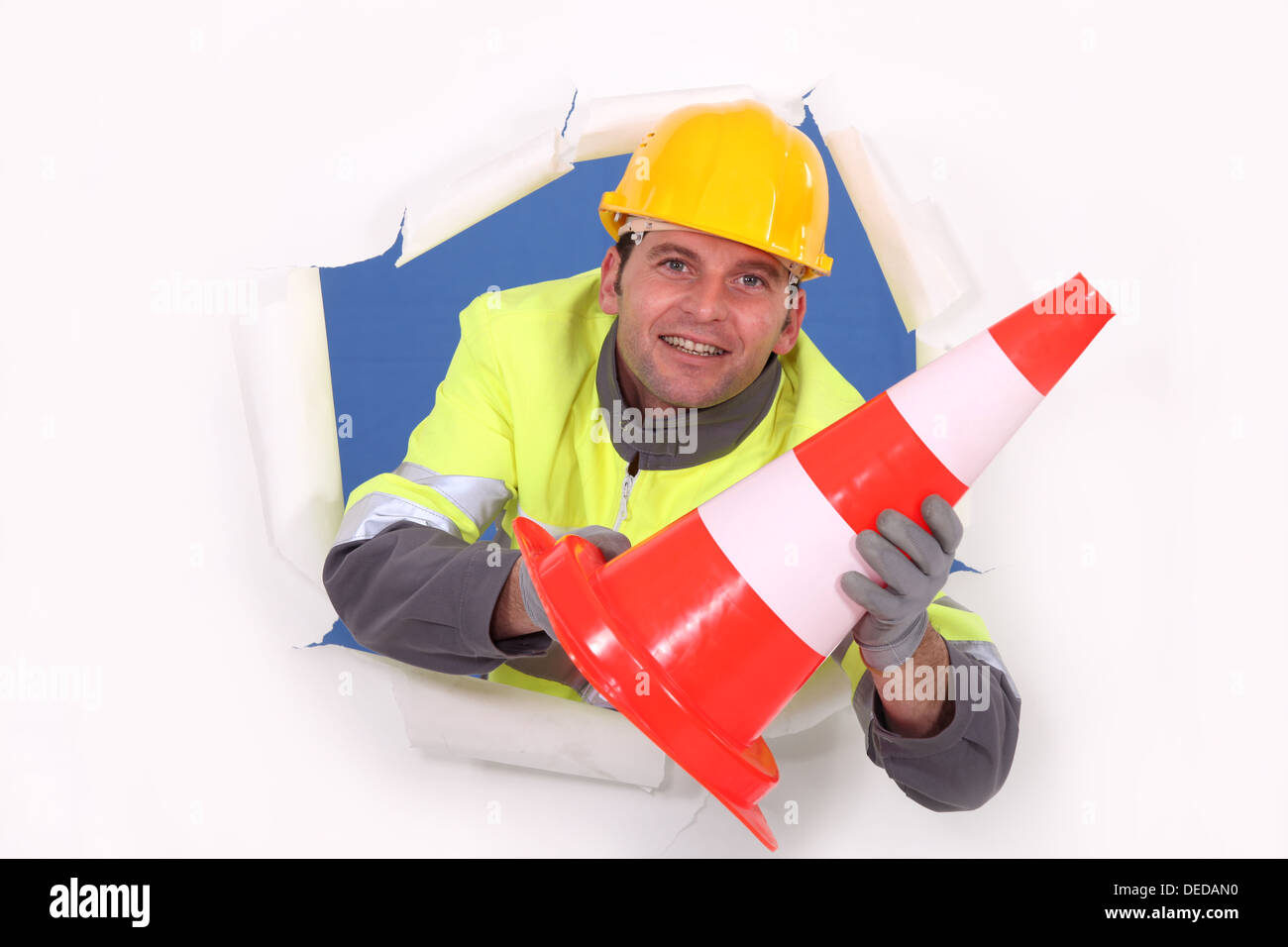 Worker holding a traffic pylon Stock Photo - Alamy