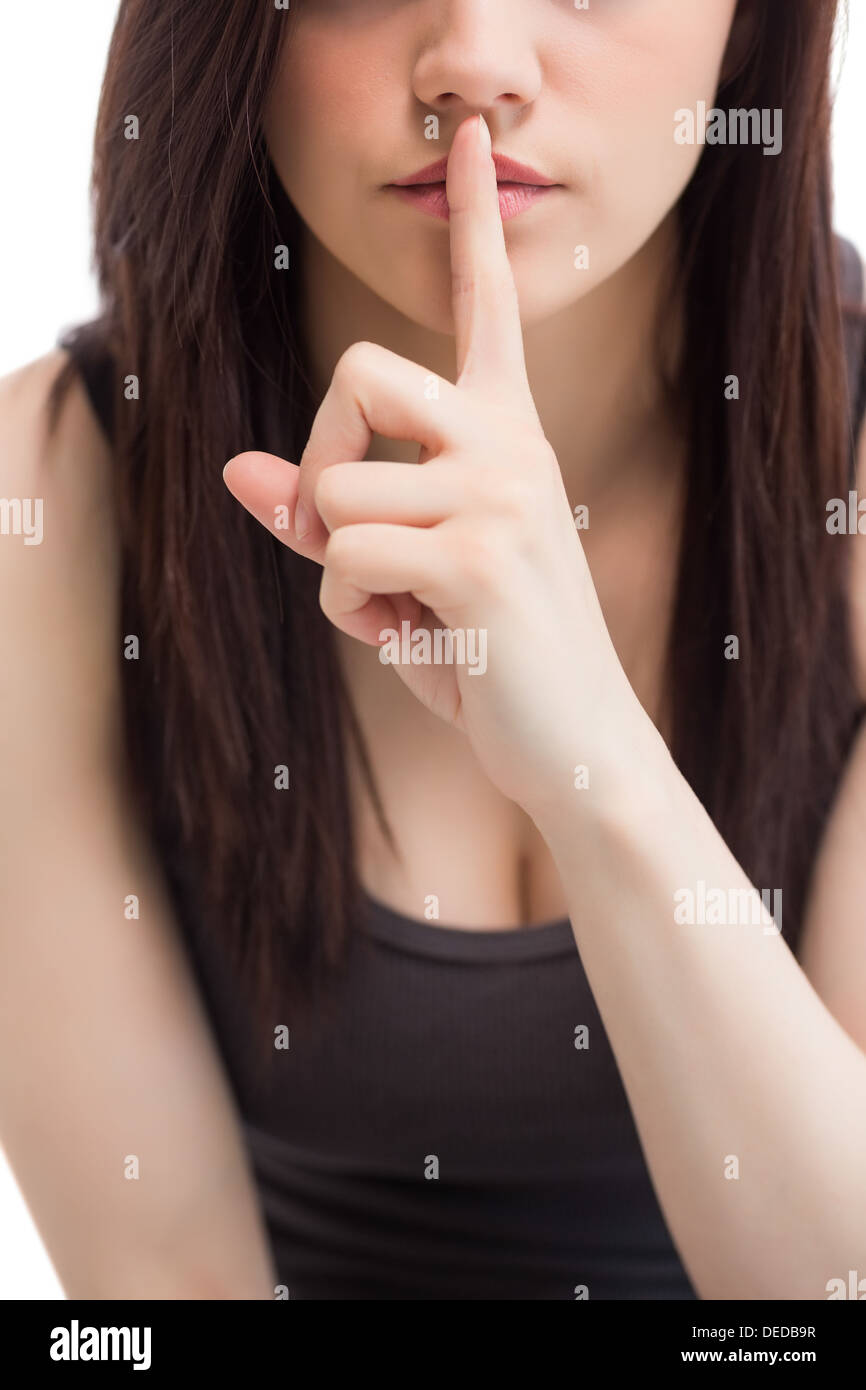 Close up on cute brunette keeping secret Stock Photo - Alamy