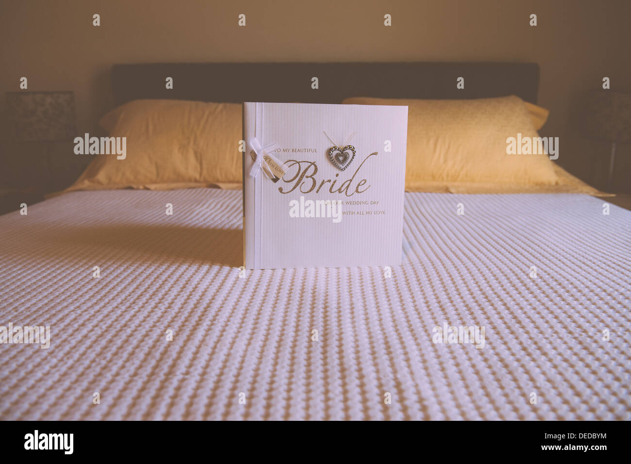 A wedding card from a groom to his bride resting on a bed Stock Photo ...
