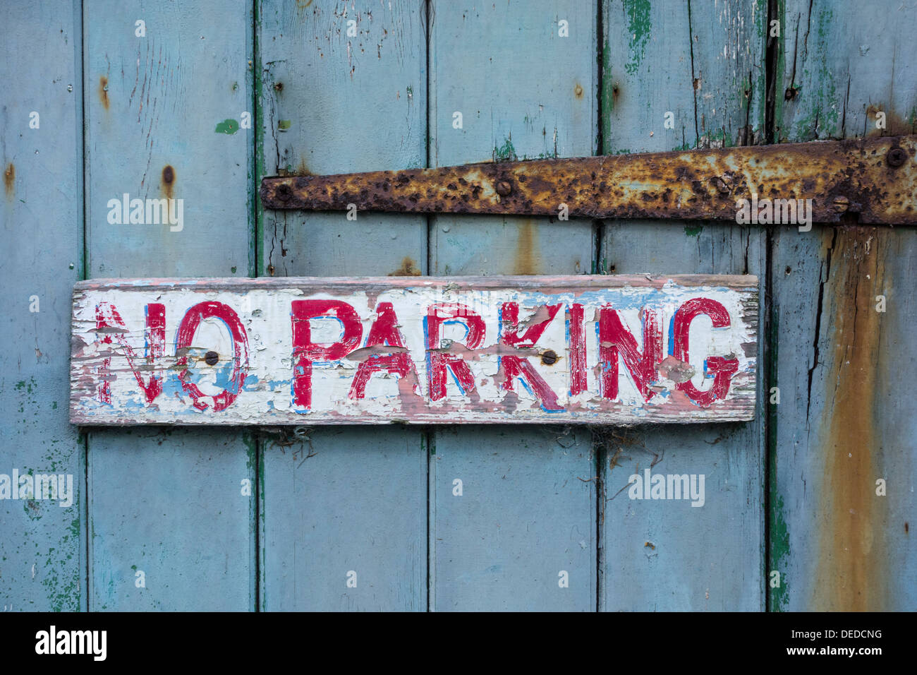 No Parking sign on weathered wooden door Stock Photo - Alamy