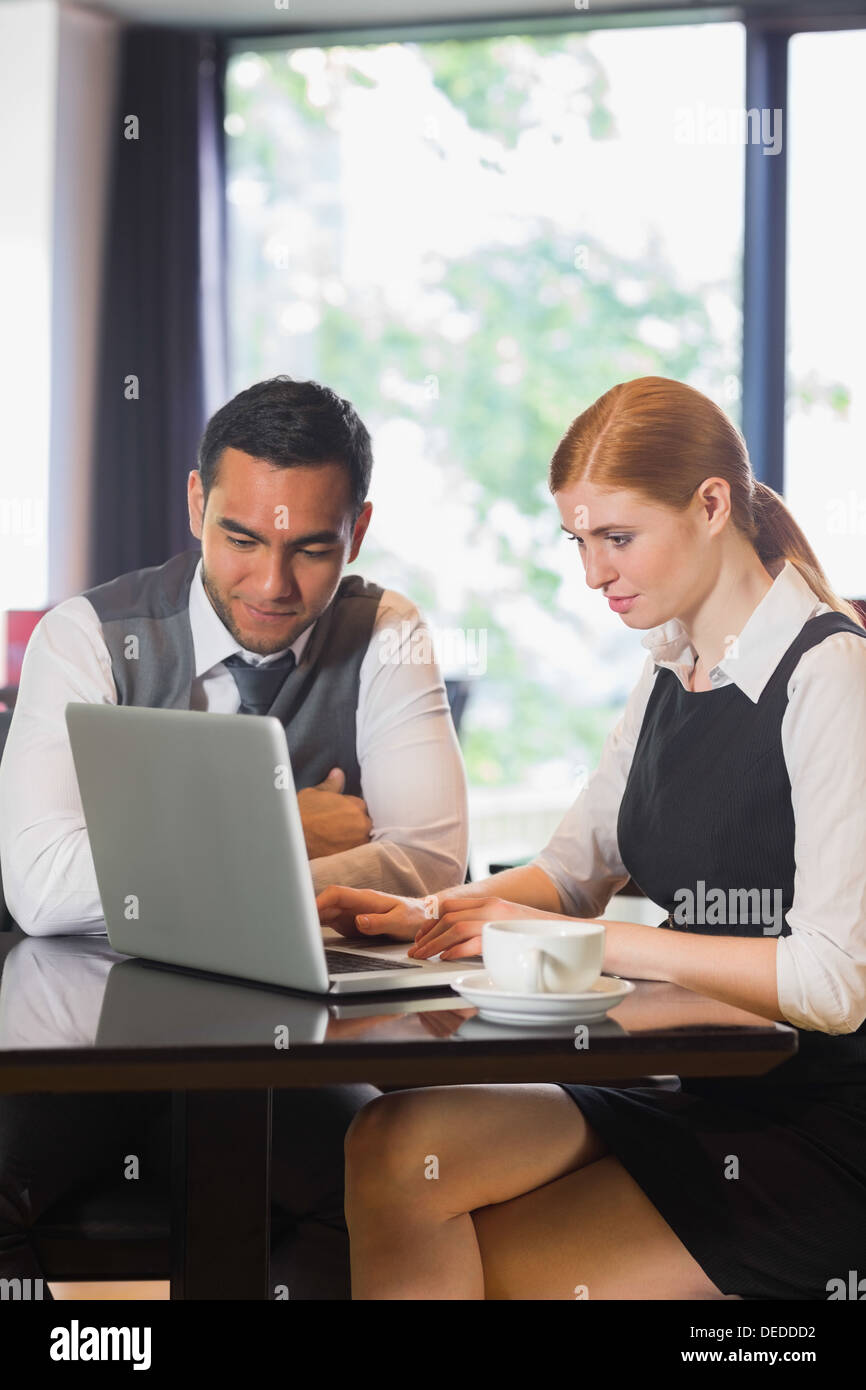 Smiling business team working together in a cafe Stock Photo - Alamy