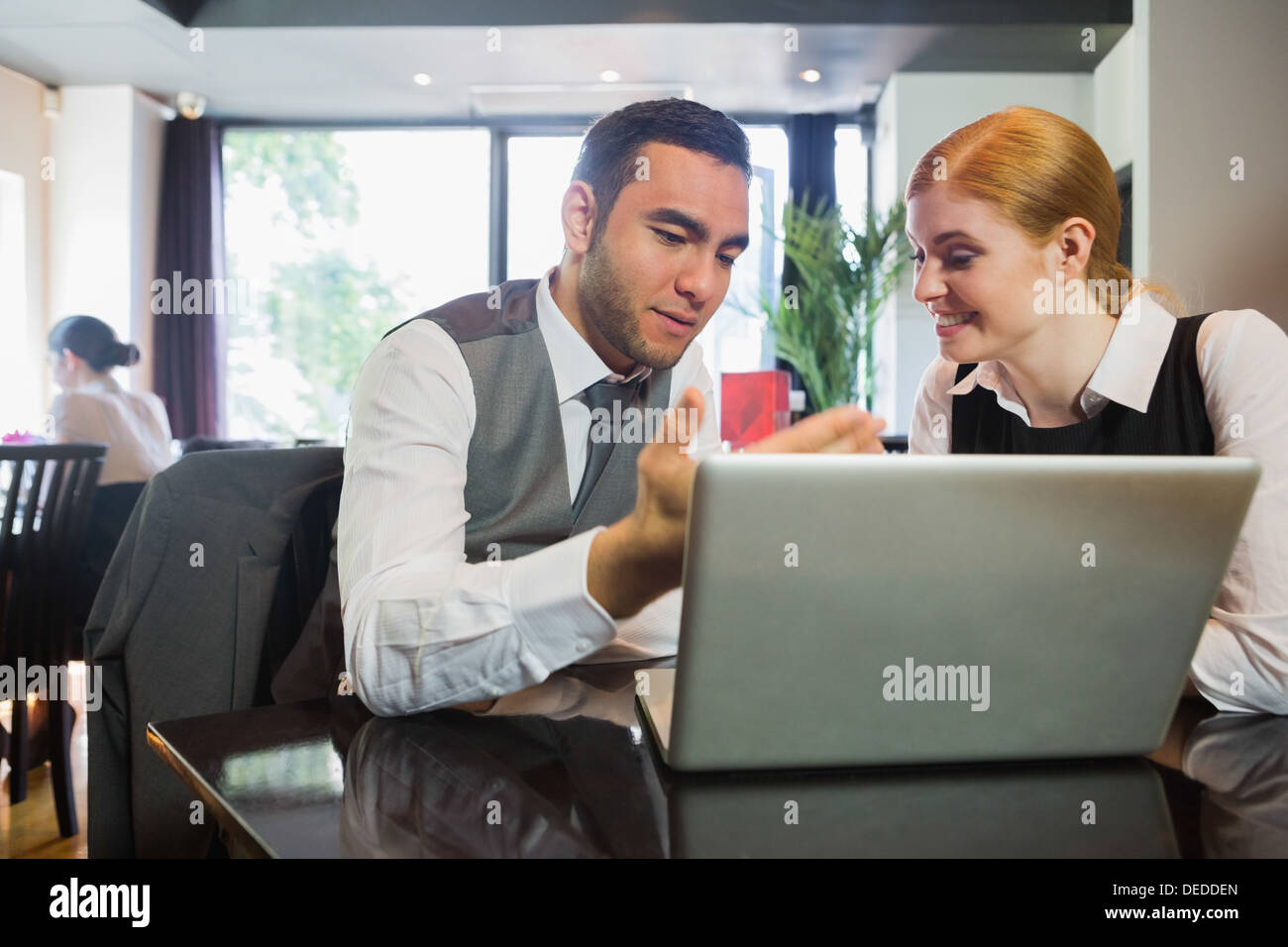 Two business people in a restaurant working together Stock Photo - Alamy