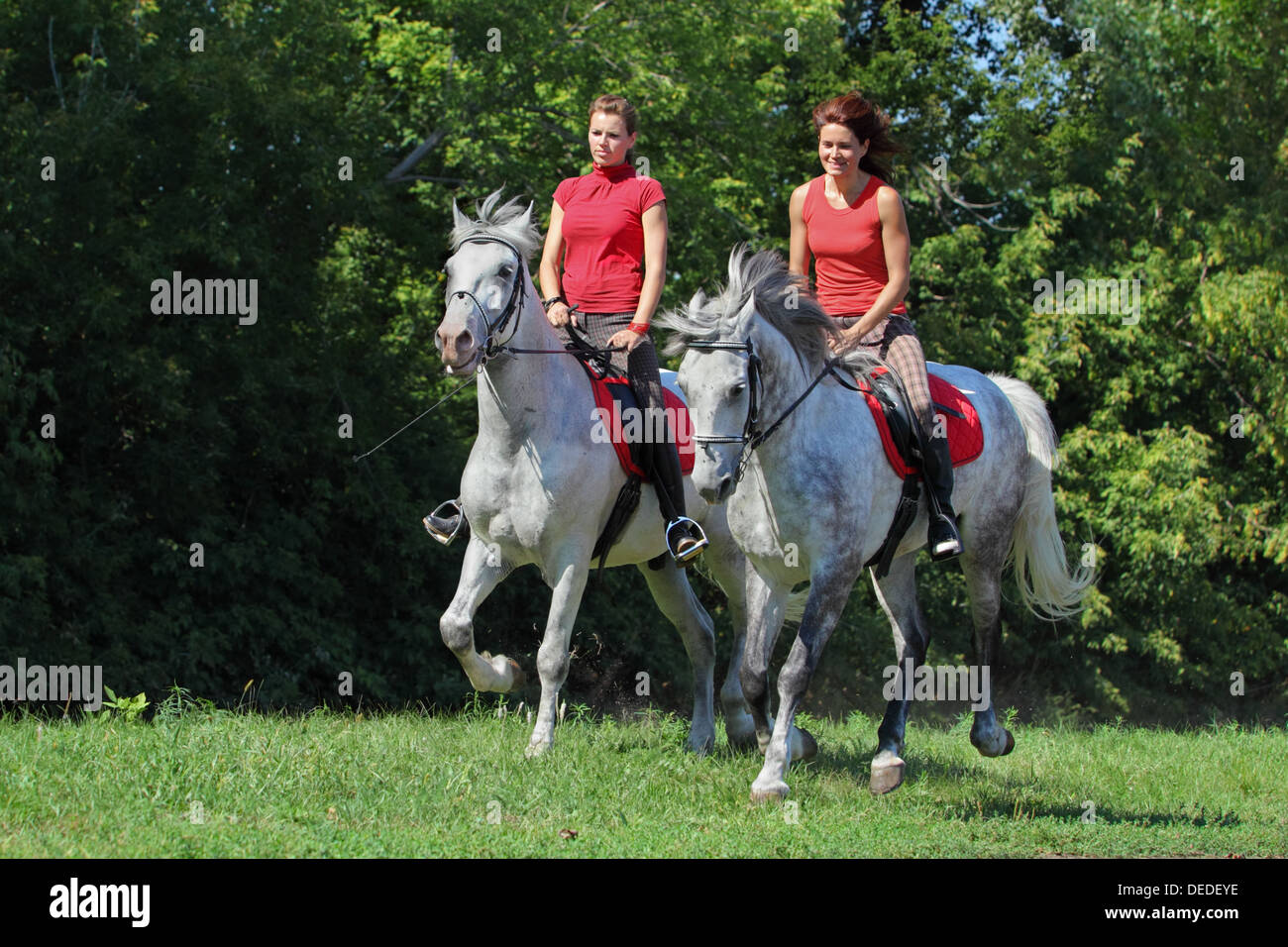 Two girls riding horse hi-res stock photography and images - Alamy