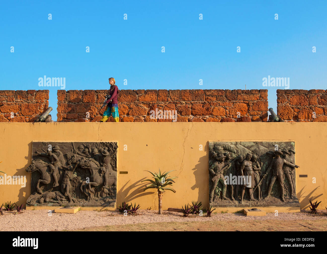 A tourist walks along the ramparts of the old Portuguese fort in Maputo ...