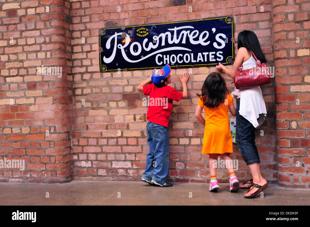 3 People pretending to eat a chocolate sign Stock Photo - Alamy