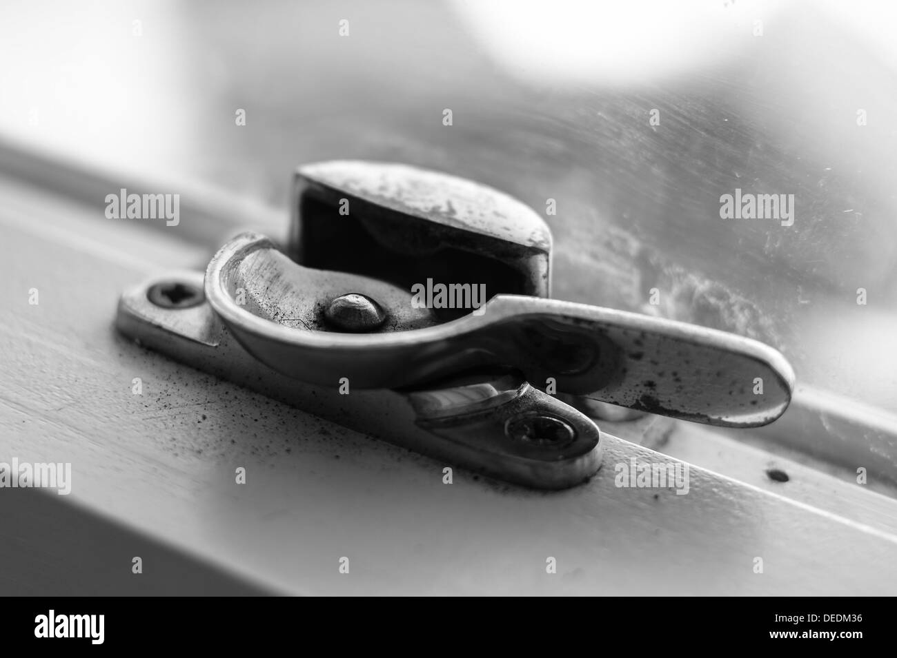 Old brass sash window latch Stock Photo - Alamy