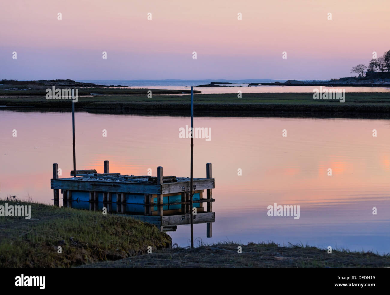 Beautiful pink and purple sunset over a Connecticut salt marsh with an ...