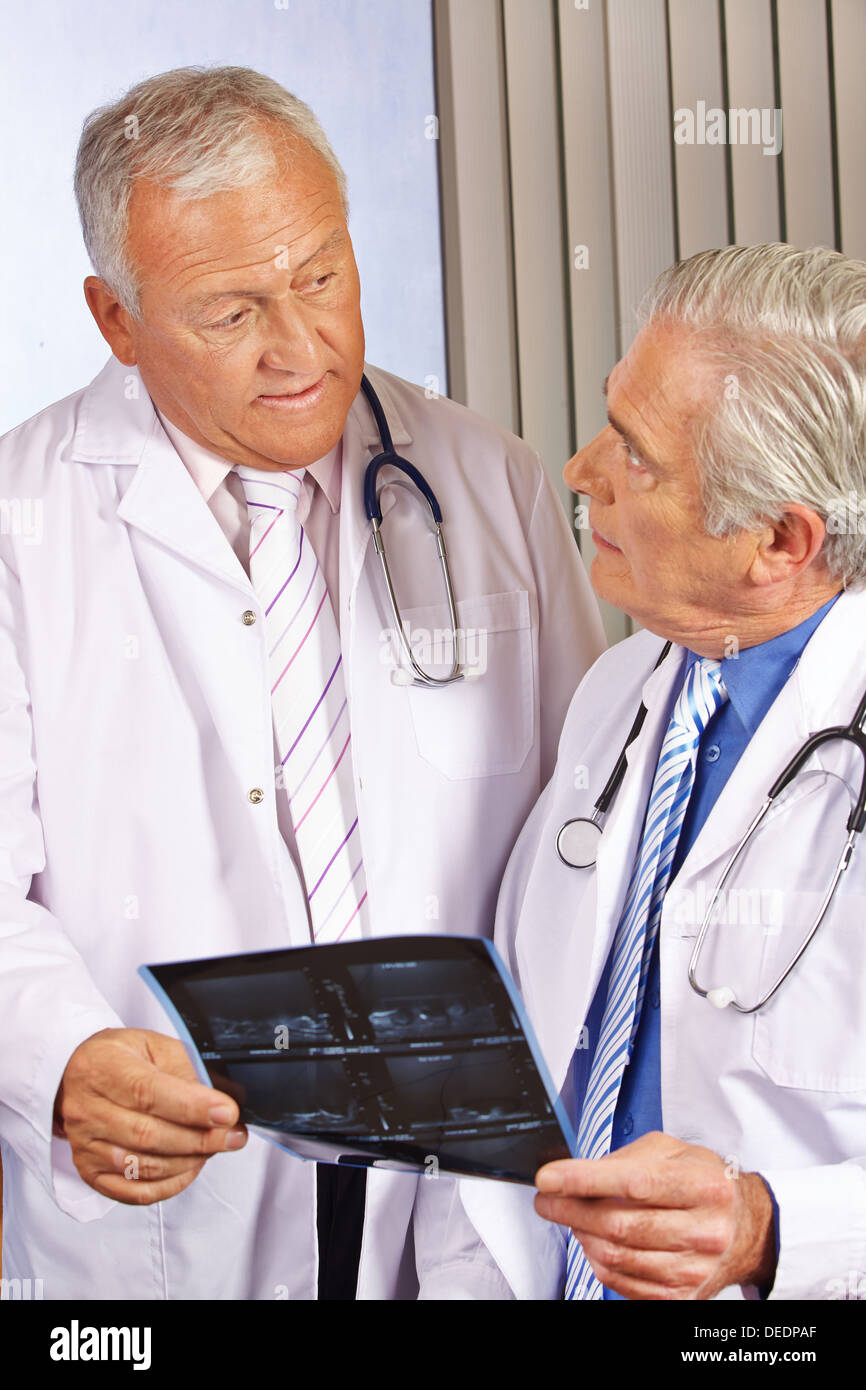 Two doctors discussing a x-rax image in the hospital Stock Photo - Alamy