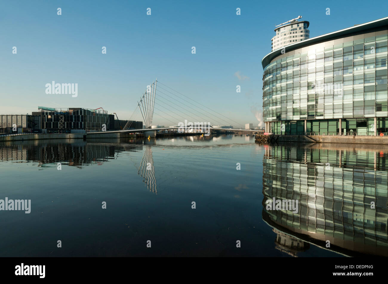 The MediaCityUK footbridge and Quay House reflected in the Manchester ...