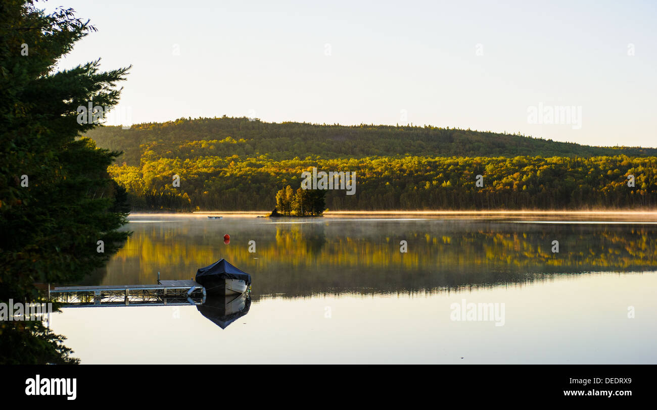 Calm water on lake in early fall with boat new brunswick Stock Photo ...