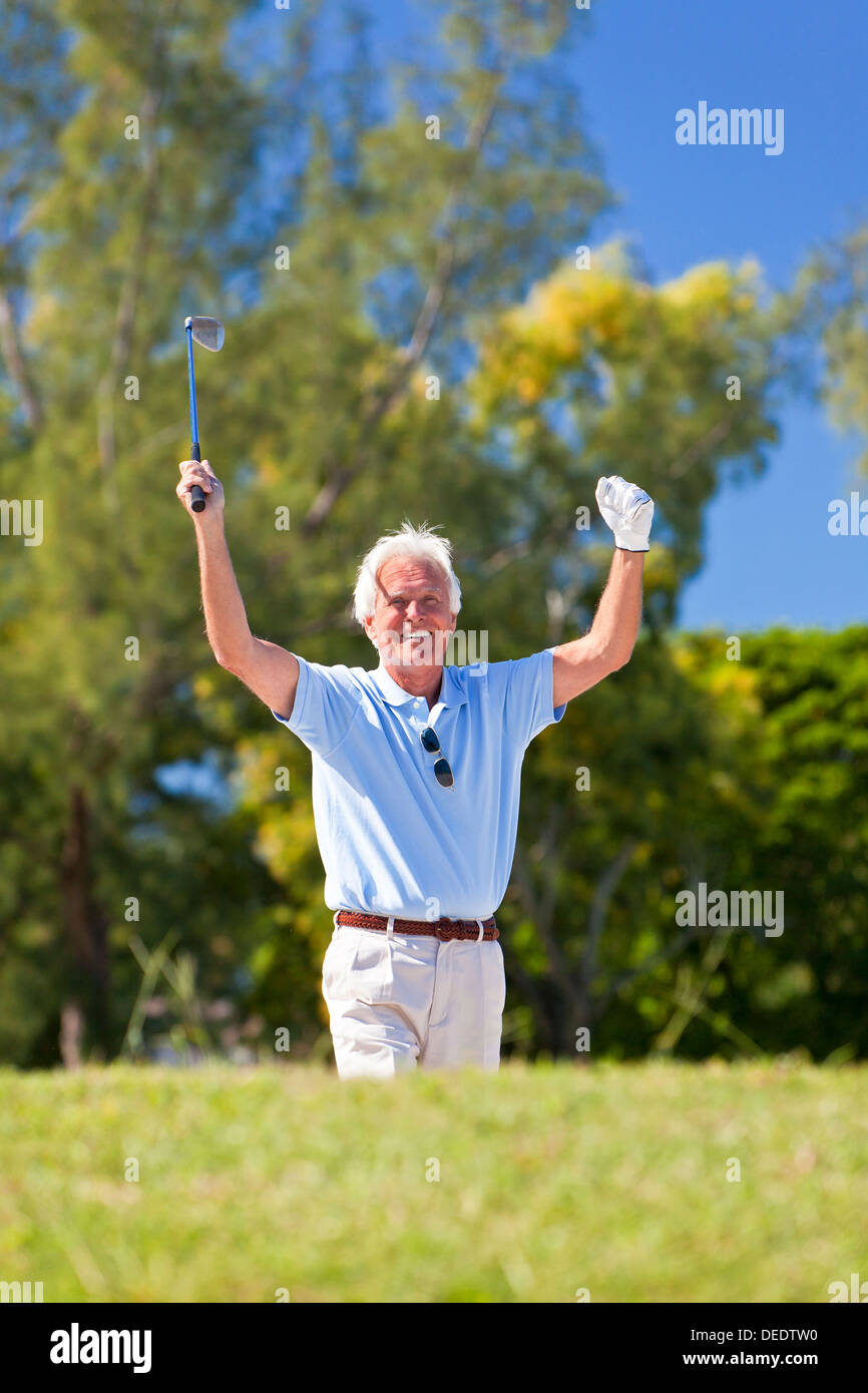 Happy senior man celebrating a successful shot playing golf Stock Photo ...