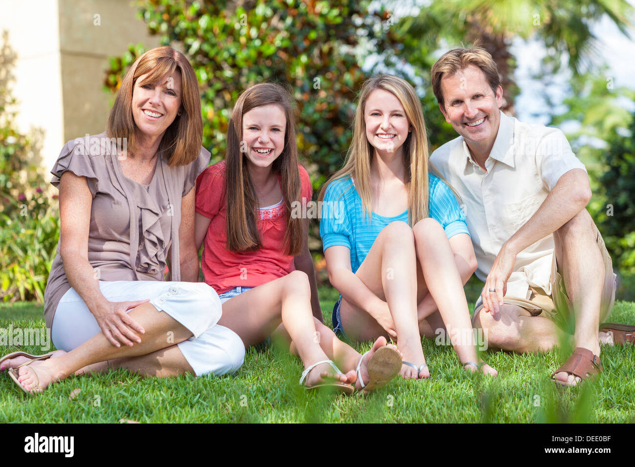 An attractive happy, smiling family of mother, father and two daughters ...