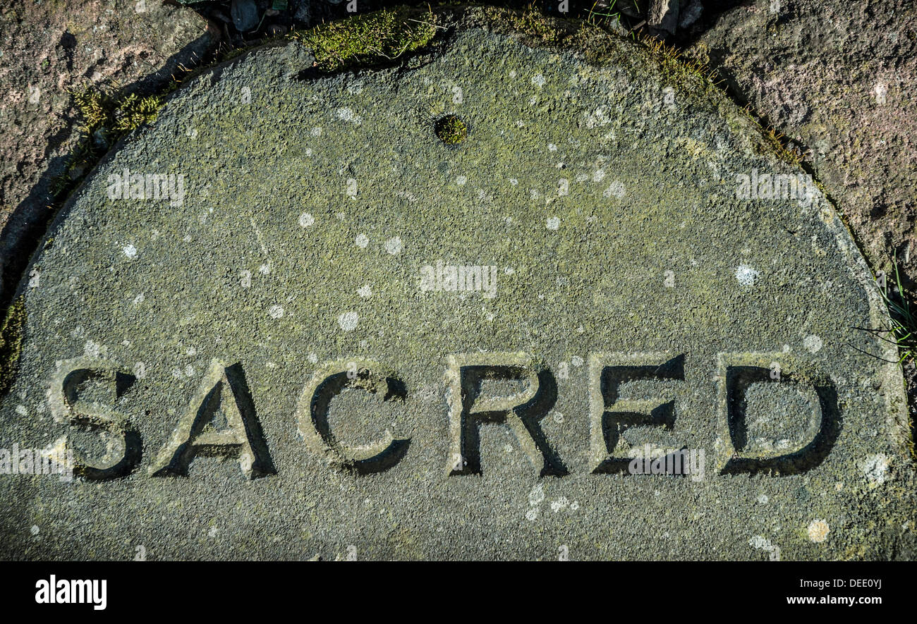 The word "sacred" carved on an old gravestone Stock Photo - Alamy