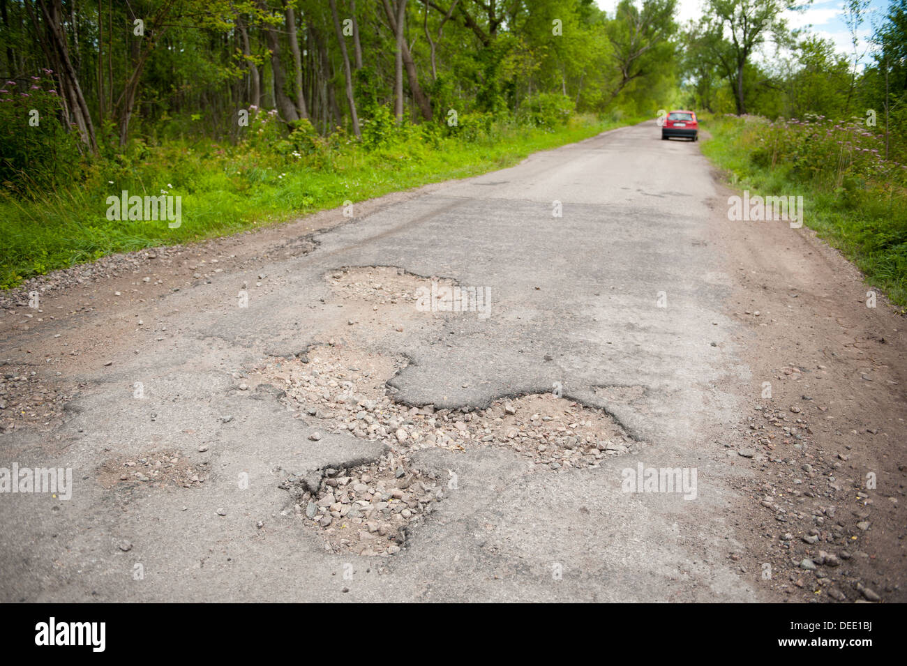 pothole and rubbles in dilapidated woods road Stock Photo - Alamy