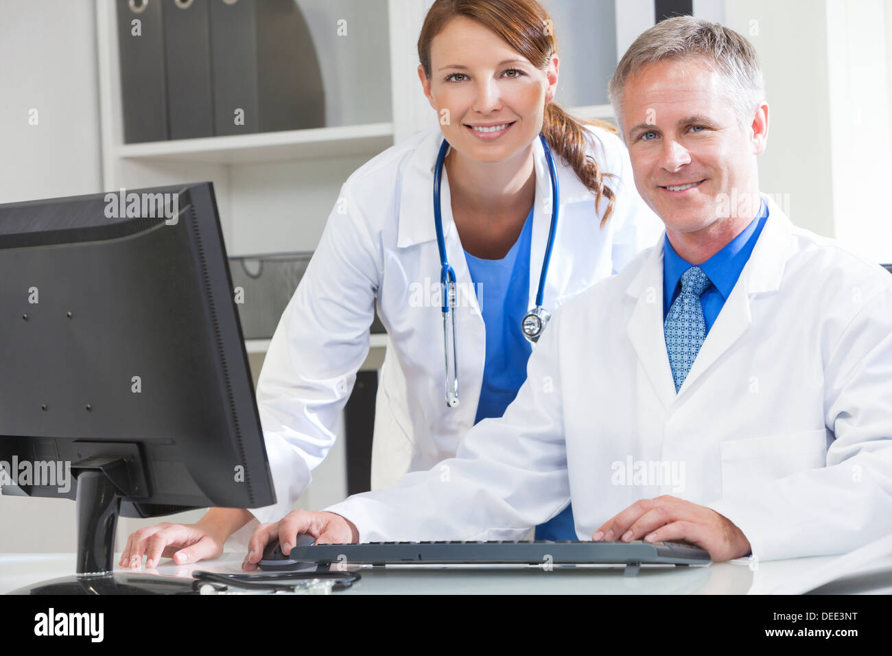 Male & female medical doctors using computer in a hospital office Stock ...