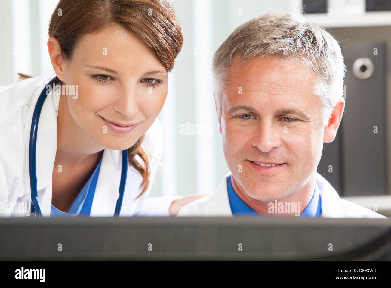 Male & female medical doctors using computer in a hospital office Stock ...