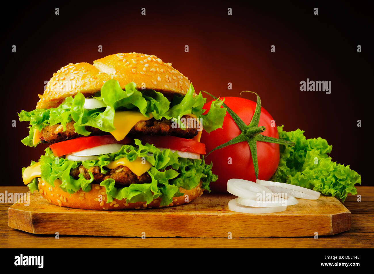 still life with double cheeseburger or hamburger and fresh vegetables ...