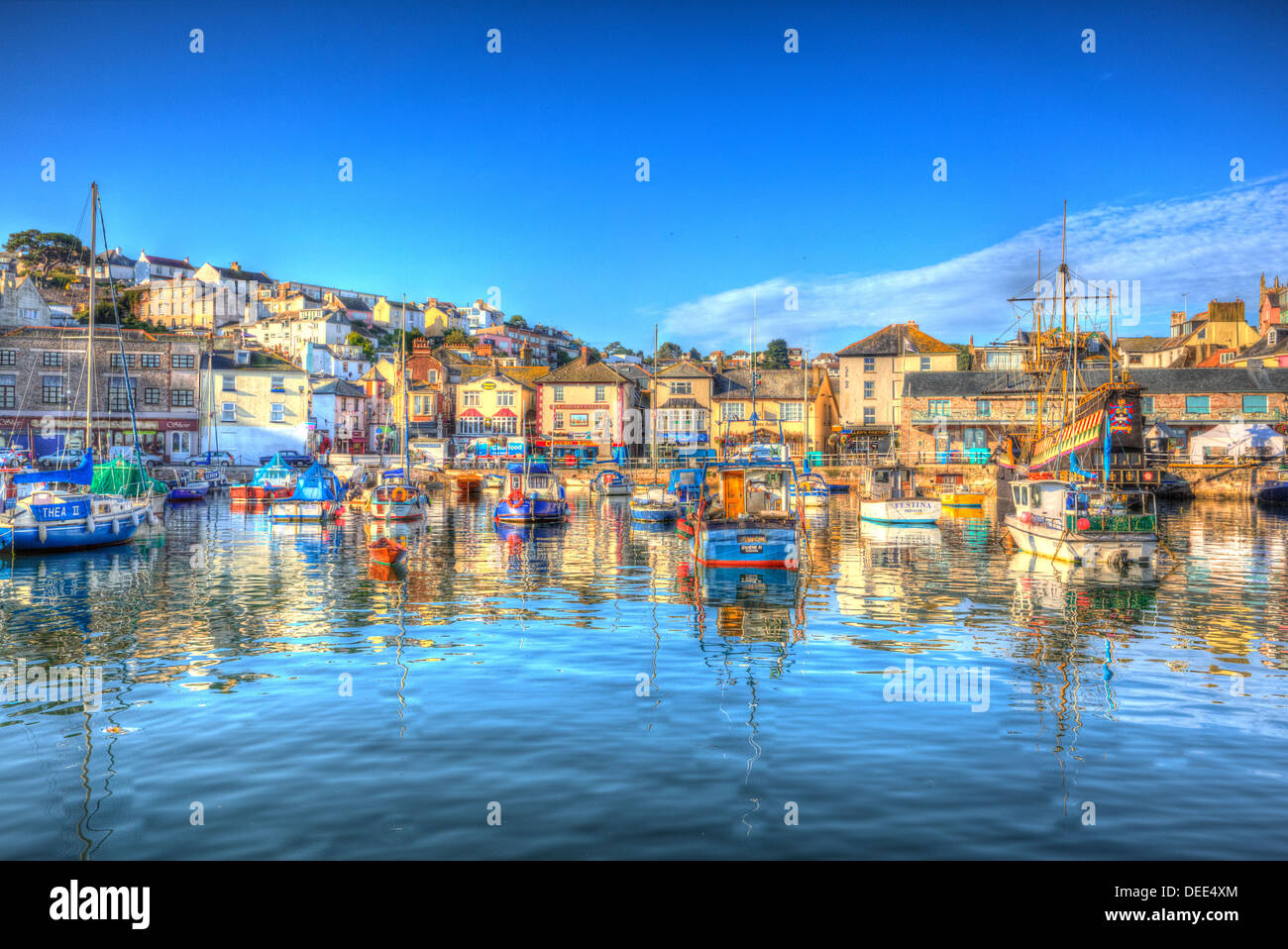 Brixham harbour Devon with boats blue sky and houses on hill in HDR ...