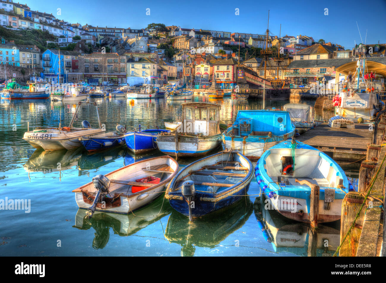 Brixham harbour Devon with boats blue sky and houses on hill in HDR ...