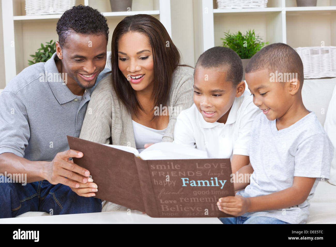 Happy African American man, woman and two boys, father, mother and sons ...