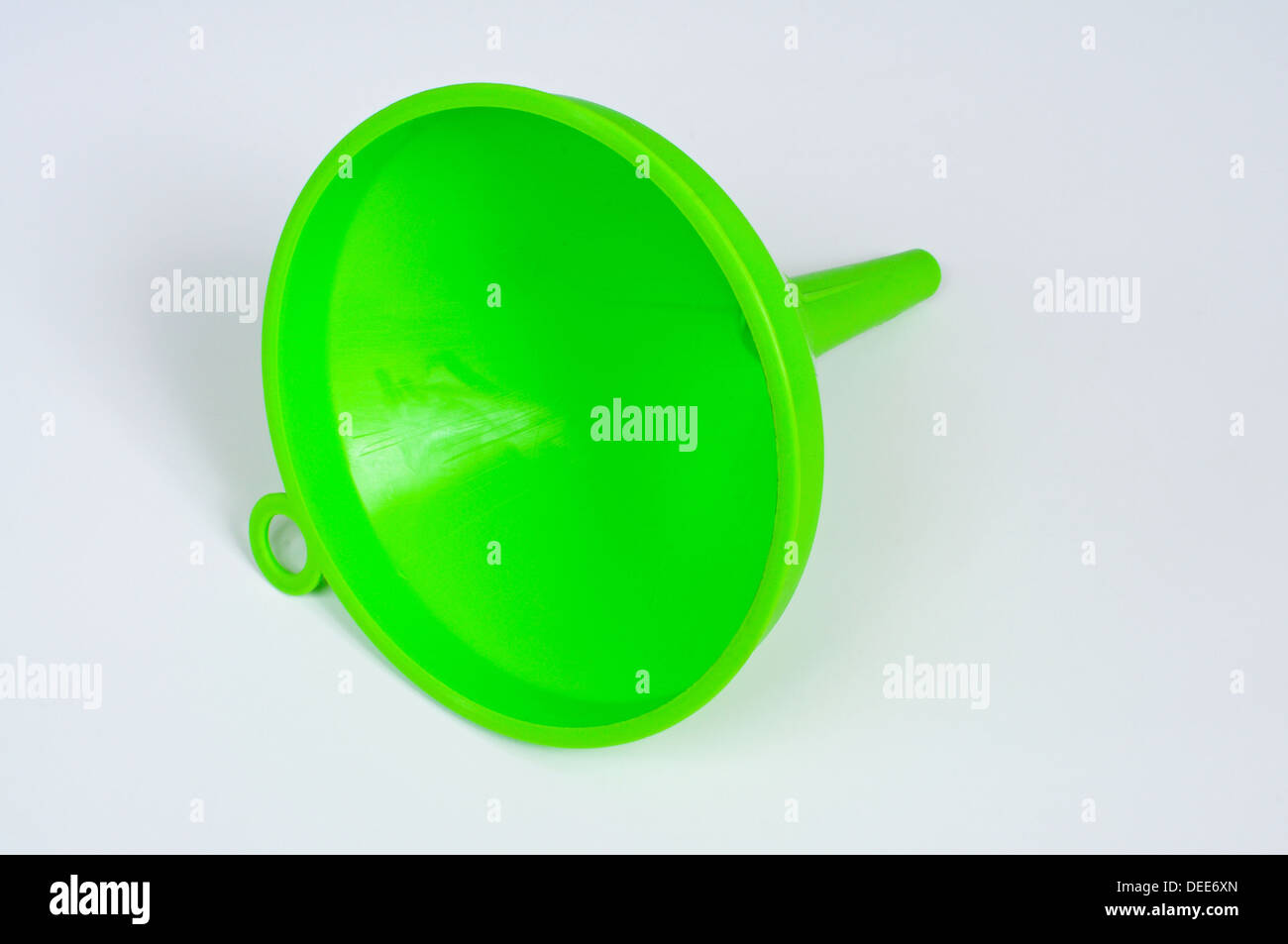 Green plastic funnels against a white background Stock Photo - Alamy