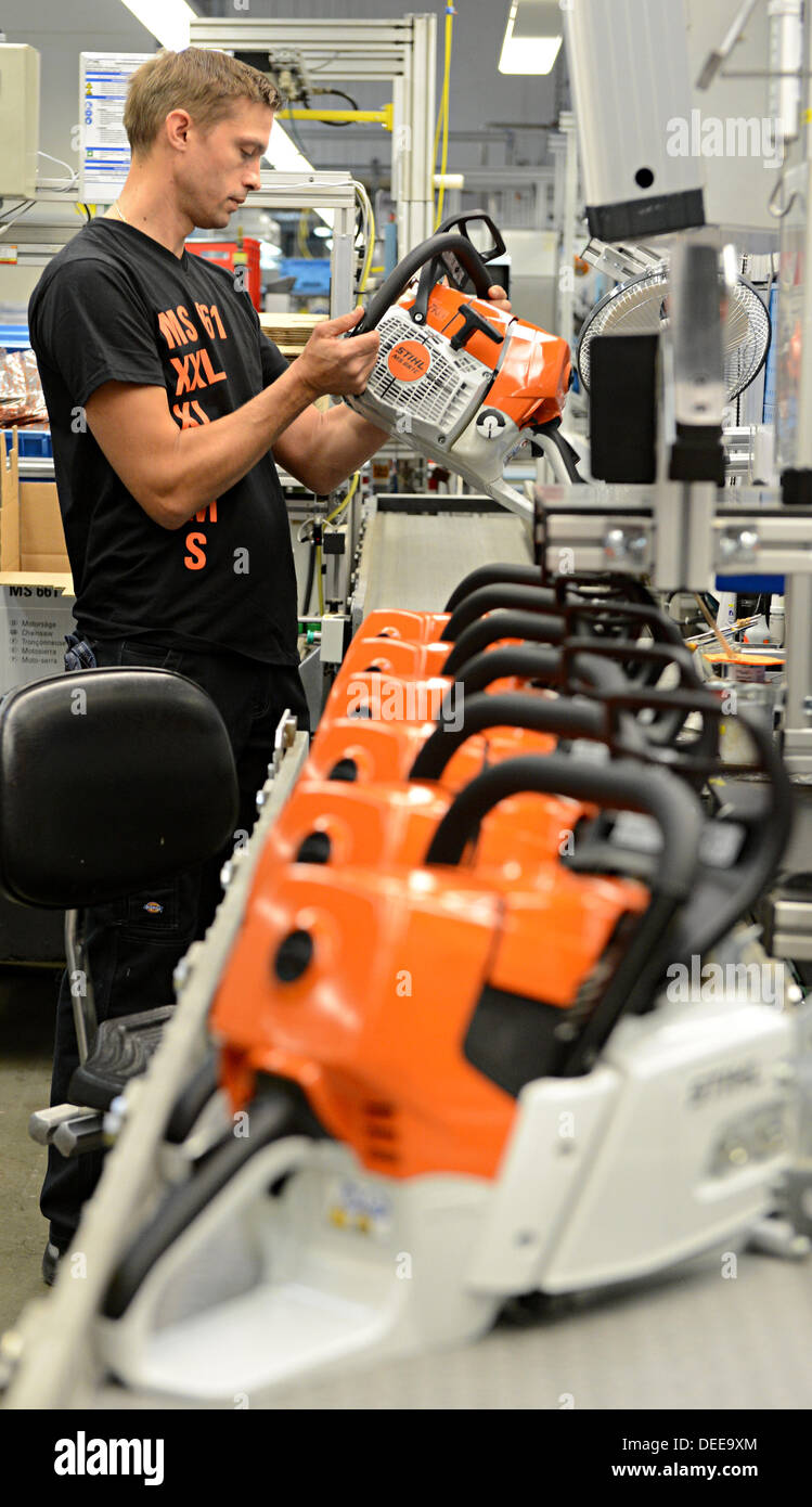 An employee of saw manufacturer Stihl works on the new saw model 'STIHL ...