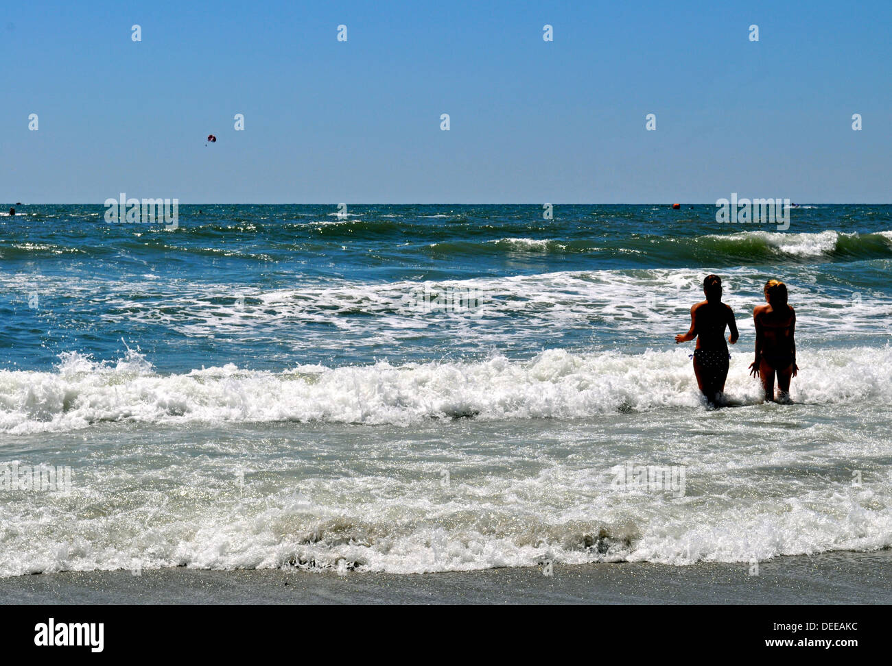 Cold waves splash over two women Stock Photo - Alamy