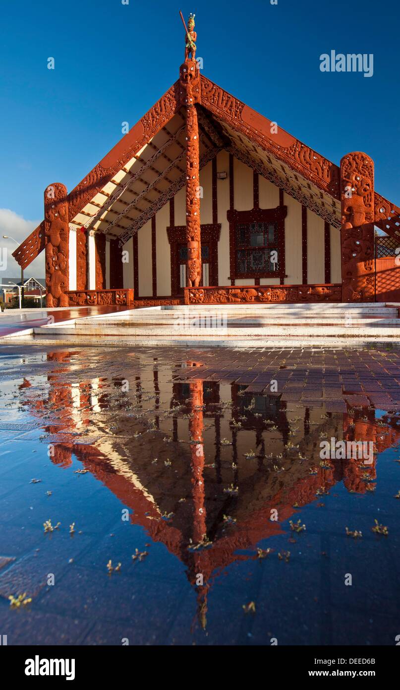 Maori marae reflection in rain puddle, Ohinemutu, Rotorua Stock Photo ...