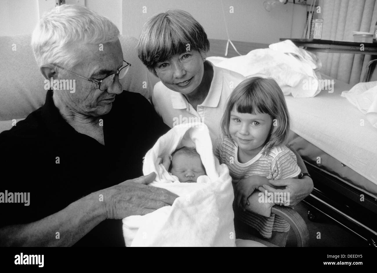 Grandfather holding newborn grandchild Black and White Stock Photos ...