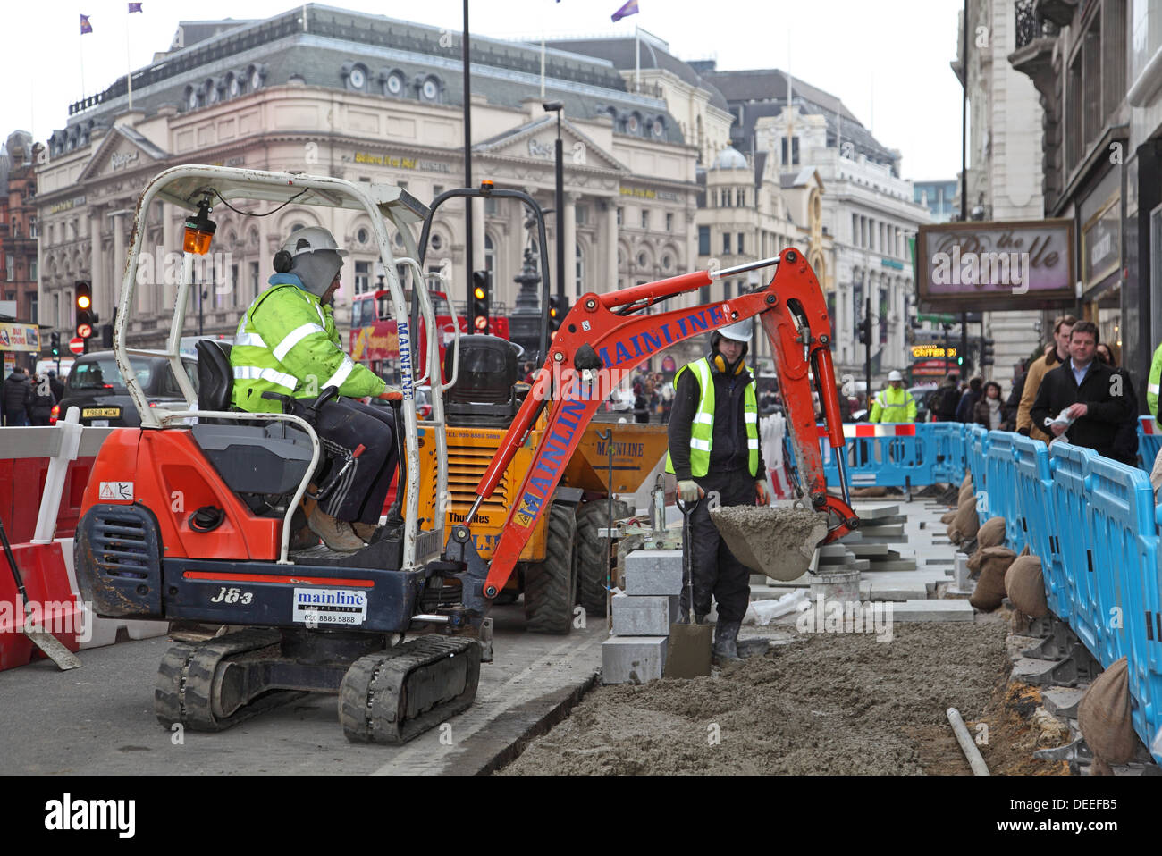 Workmen mini excavator place kerb pavements hi-res stock photography ...